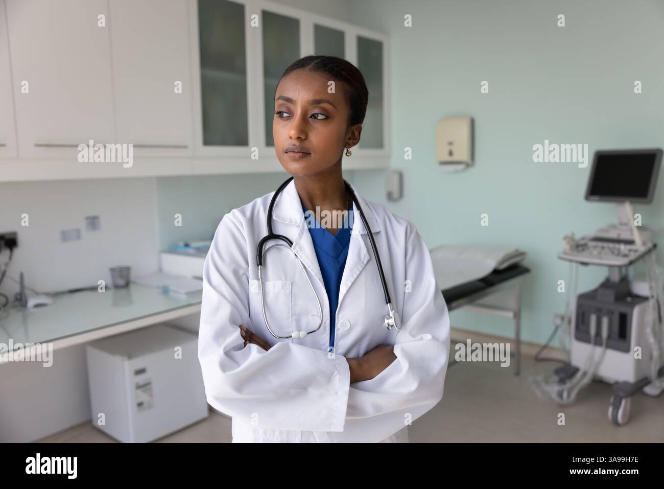 Pensive Black doctor woman standing in ultrasound diagnosing lab Stock ...