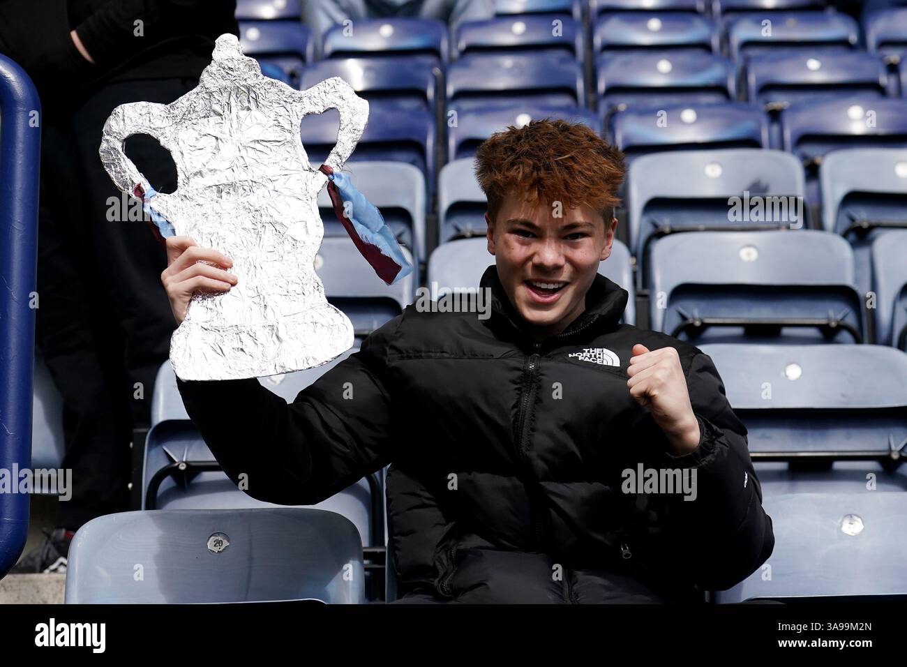 An Aston Villa fan holding a tinfoil replica FA Cup trophy in the ...
