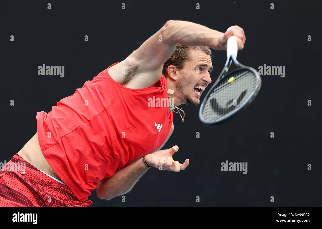 German tennis player Alexander Zverev playing service shot at Australian Open 2025 tournament ...