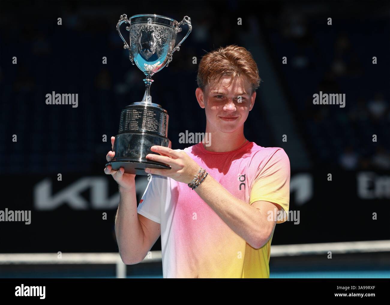 Swiss junior Grand Slam winner Henry Bernet (SUI) holding up the trophy ...