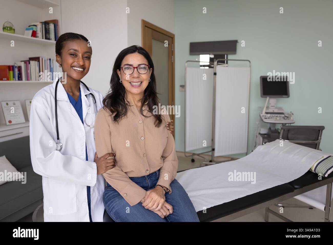 Positive caring young African doctor woman touching shoulders of ...