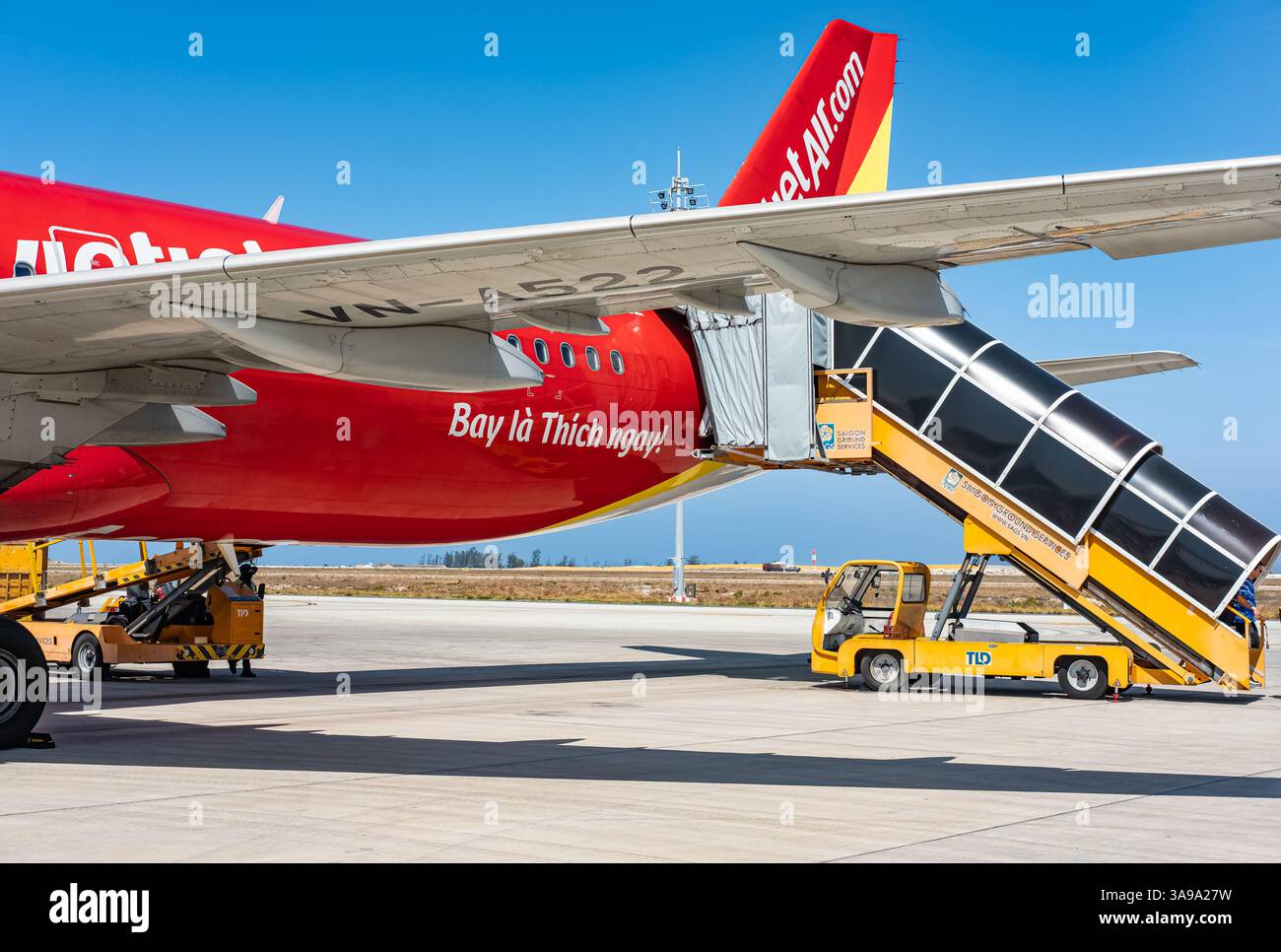 Passenger boarding stairs next to VietAir plane. Ladder at the rear ...