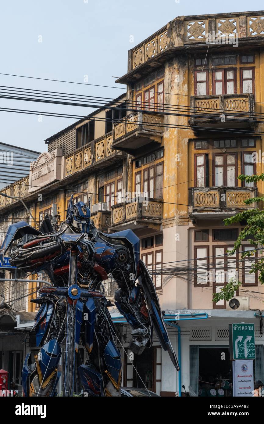 The Optimus Prime statue in front of the traditional architecture of ...