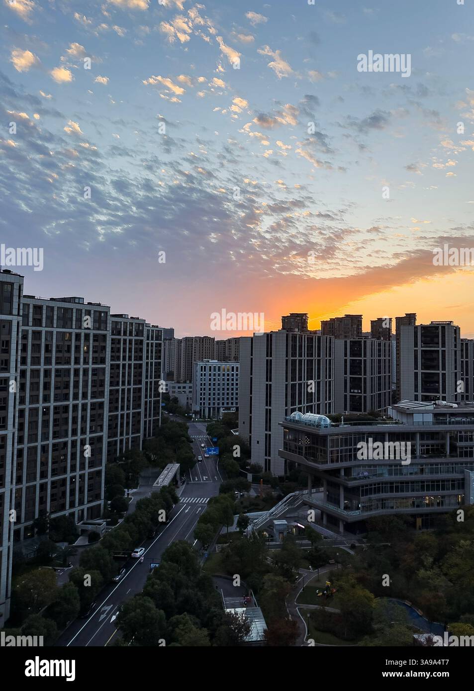 Vibrant sunset illuminating city skyline with modern buildings in ...