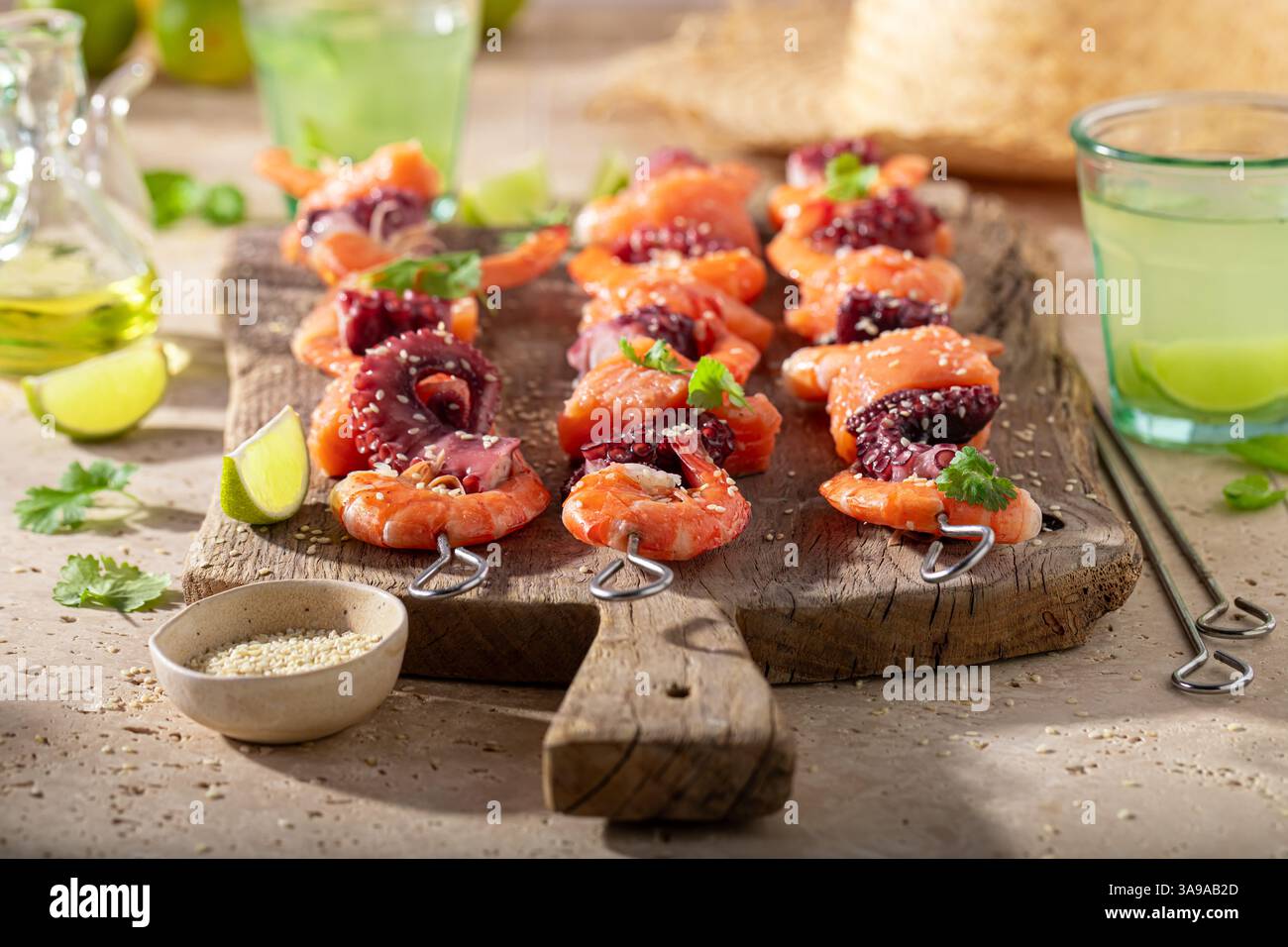 Preparation of spicy grilled skewer with salmon and octopus. Summer ...