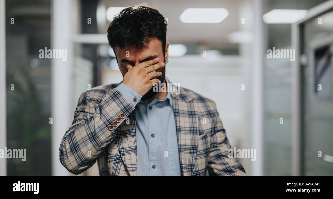 Stressed employee experiencing emotional moments at the workplace ...