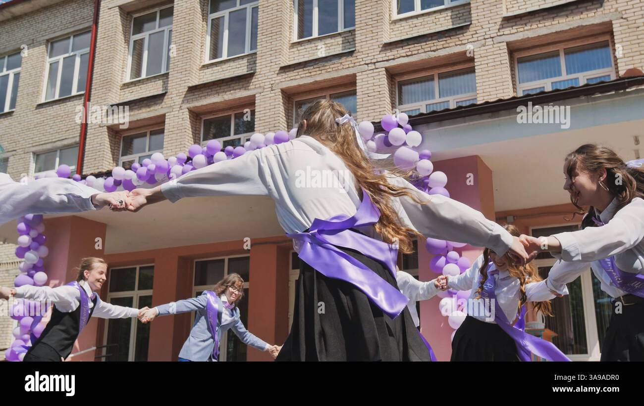 Students joyfully dancing in a circle, marking their last day of school ...