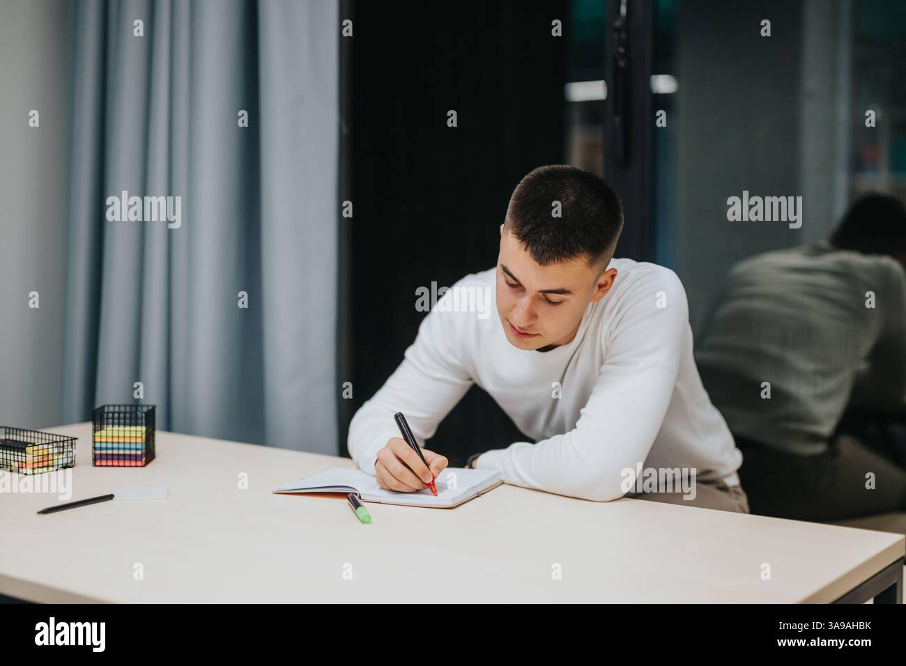 Focused high school student taking notes during class Stock Photo - Alamy