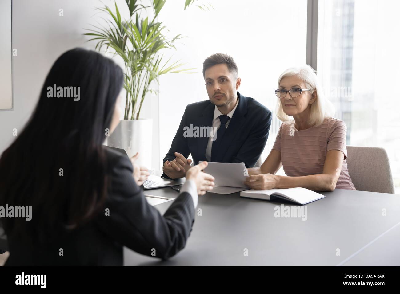 Rear view female applicant passing job interview in company office ...