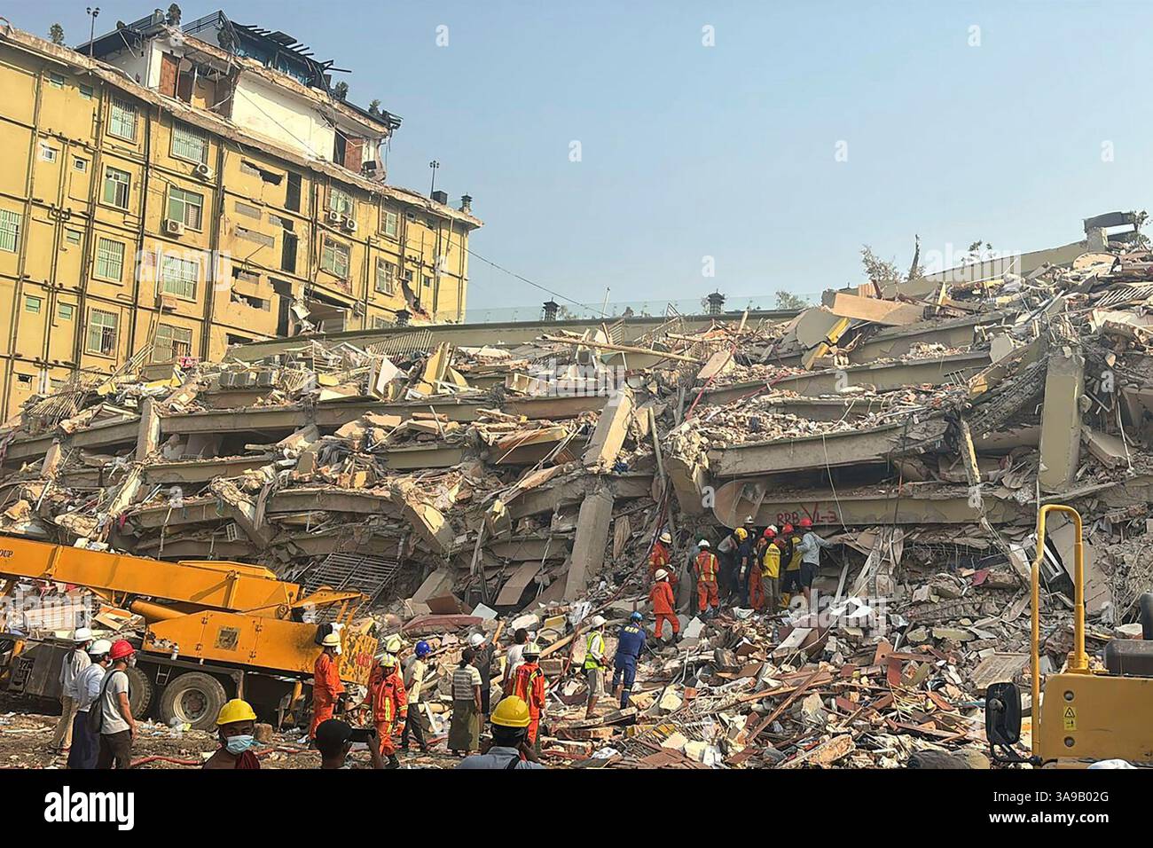Rescuers work at the Sky Villa Condo that collapsed In Friday's ...