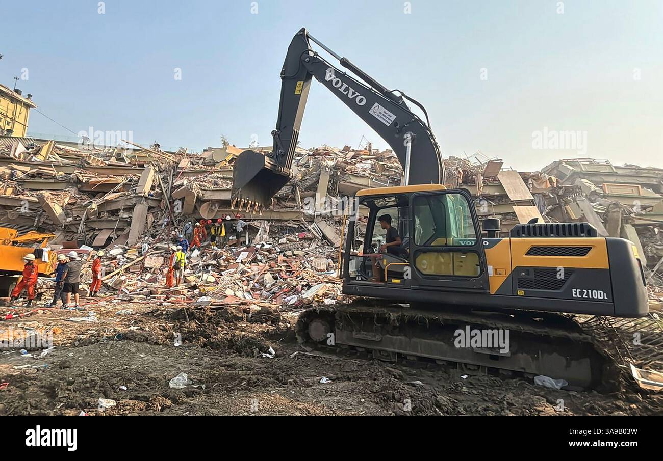 Rescuers work at the site of a building that collapsed In Friday's ...