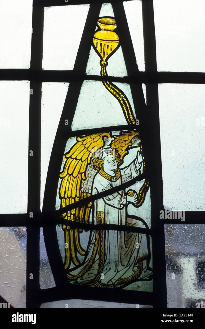 Angel with magnificent golden wings swings incense censer above head ...