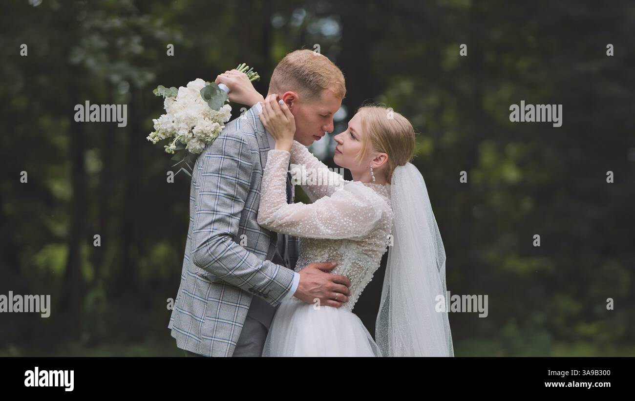 Loving newlyweds hugging amid woodland trees, sharing intimate moment ...
