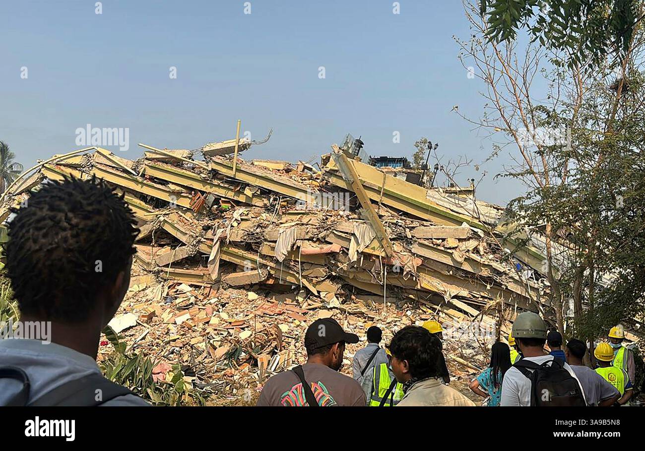 People watch rescue operation at Sky Villa Condo that collapsed In ...
