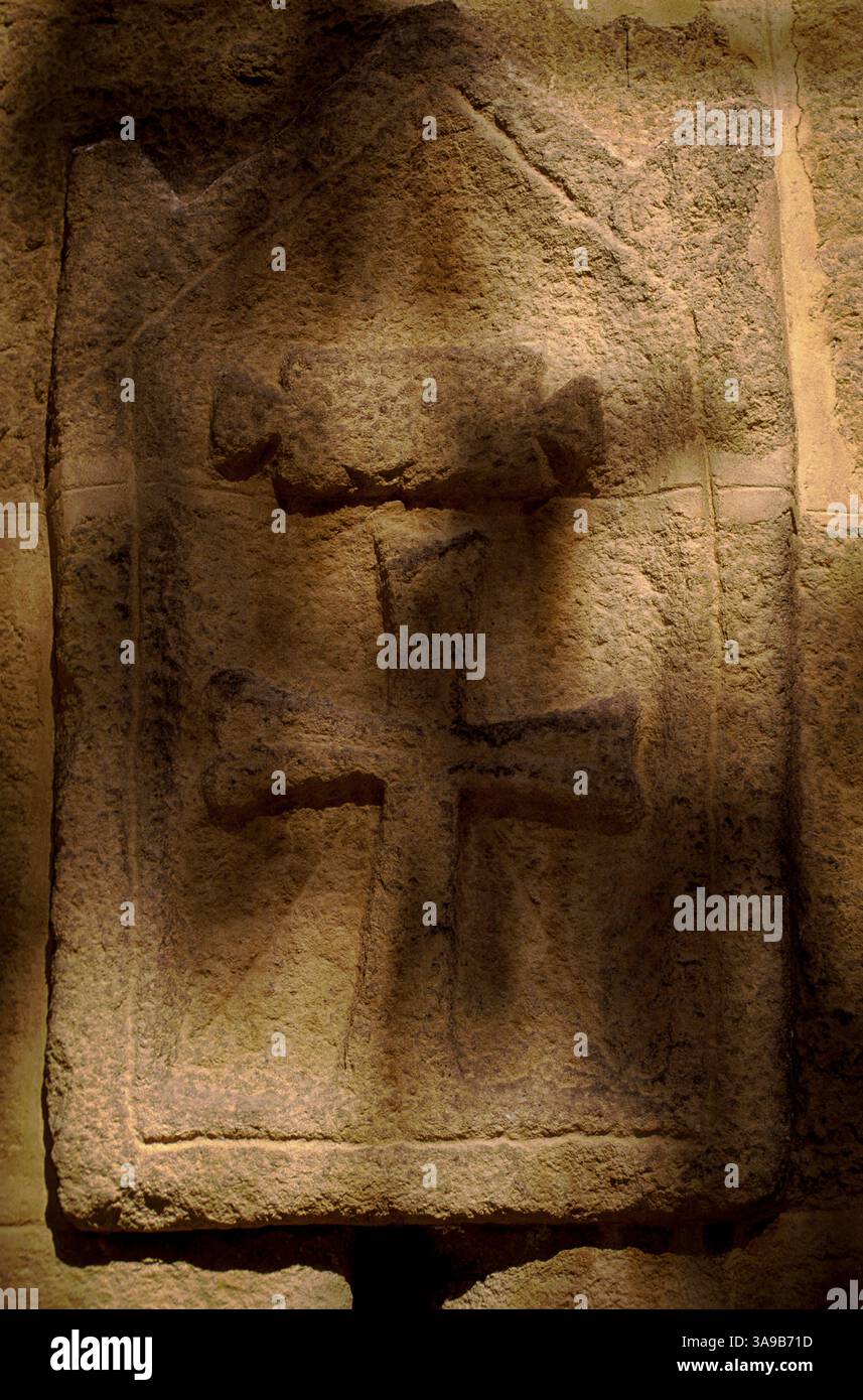 Byzantine eight-pointed cross sculpted on massive ancient granite walls ...