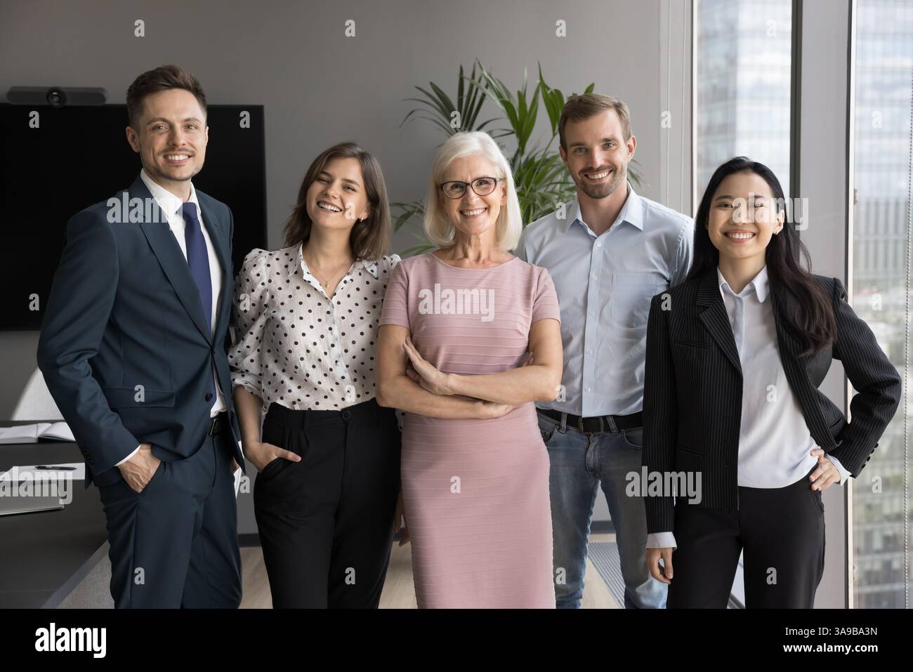 Portrait of five international staff members posing at workplace Stock ...