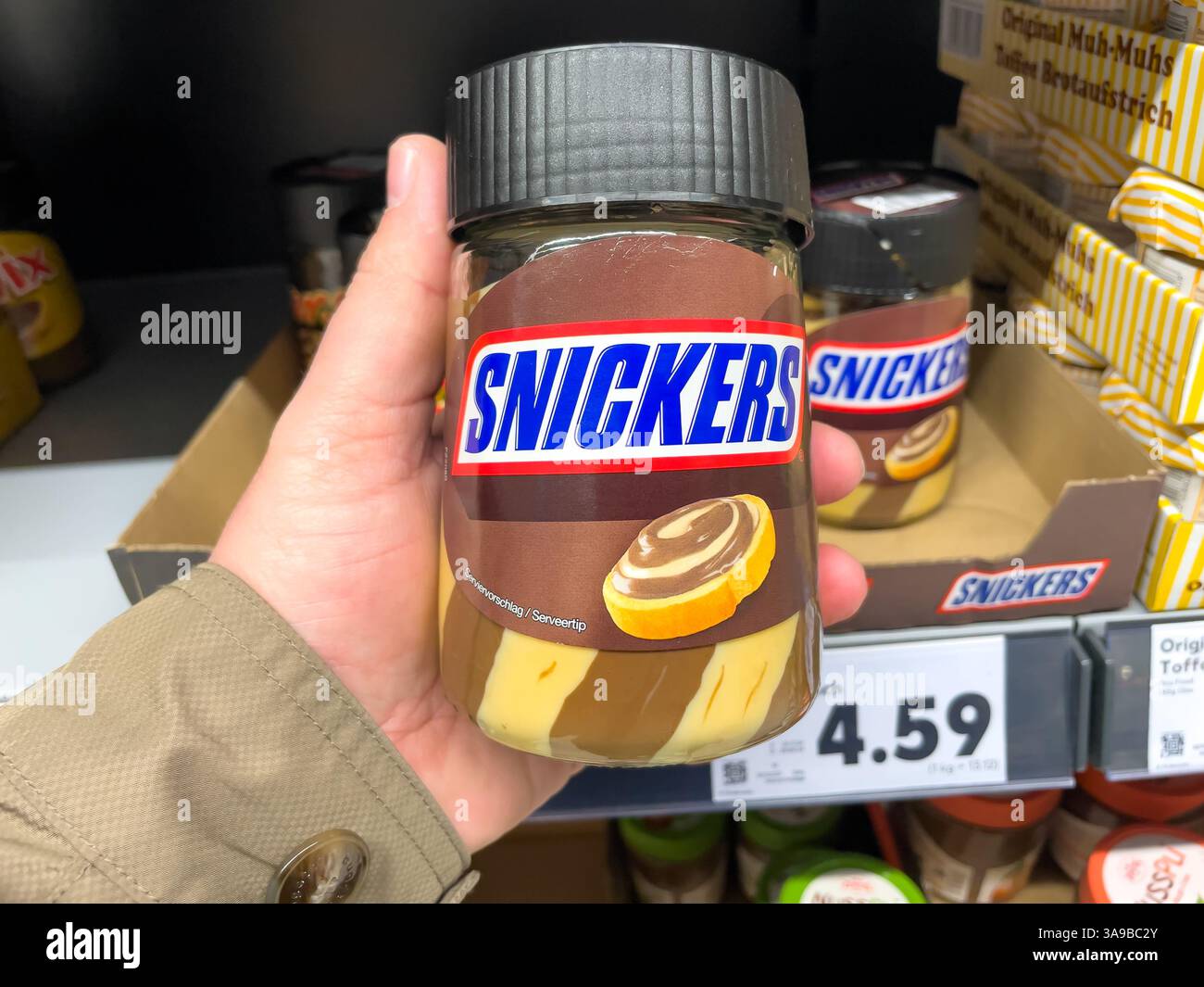 Germany Berlin March 29, 2025. A jar of Snickers is being held by a ...