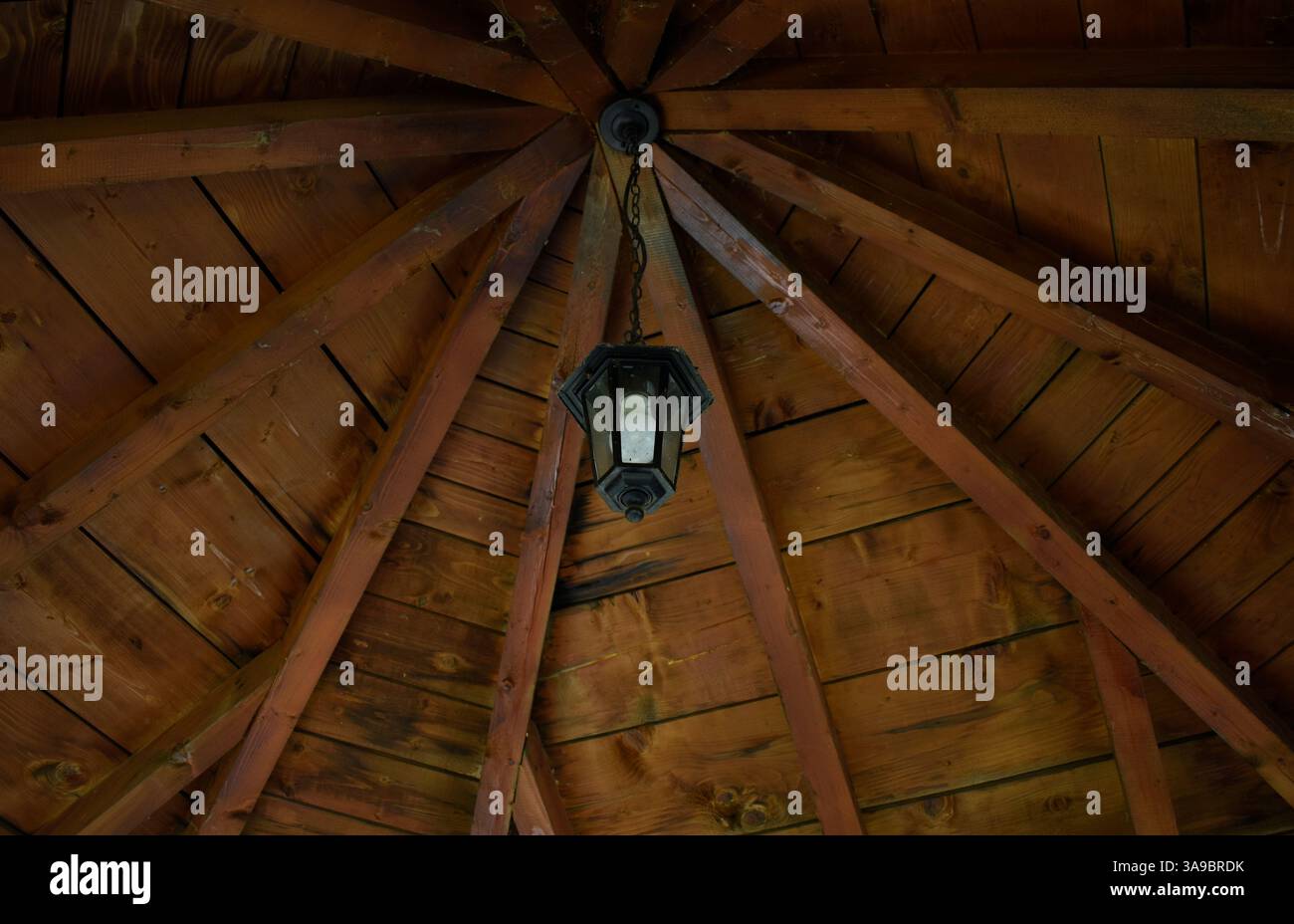 An ornate hanging lighting under the wooden roof Stock Photo - Alamy