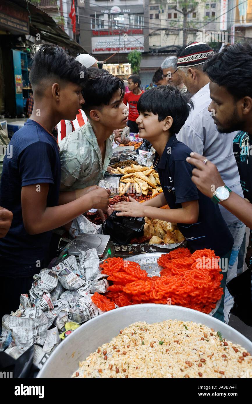 A customer haggles with a street food vendor in Kolkata, West Bengal ...