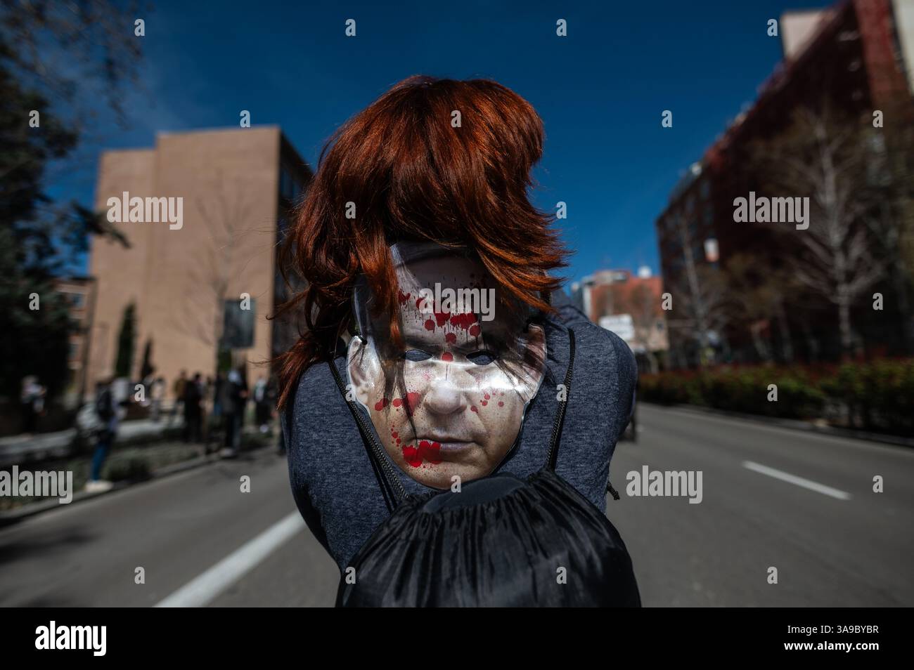 A woman carrying a blood-stained mask of Benjamin Netanyahu during a ...