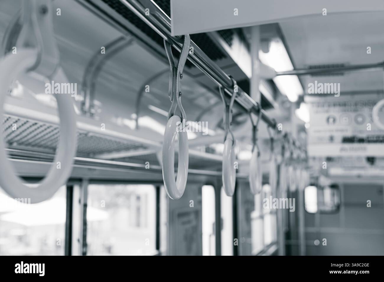 Closeup subway underground train passenger handle ring hand grip hold ...