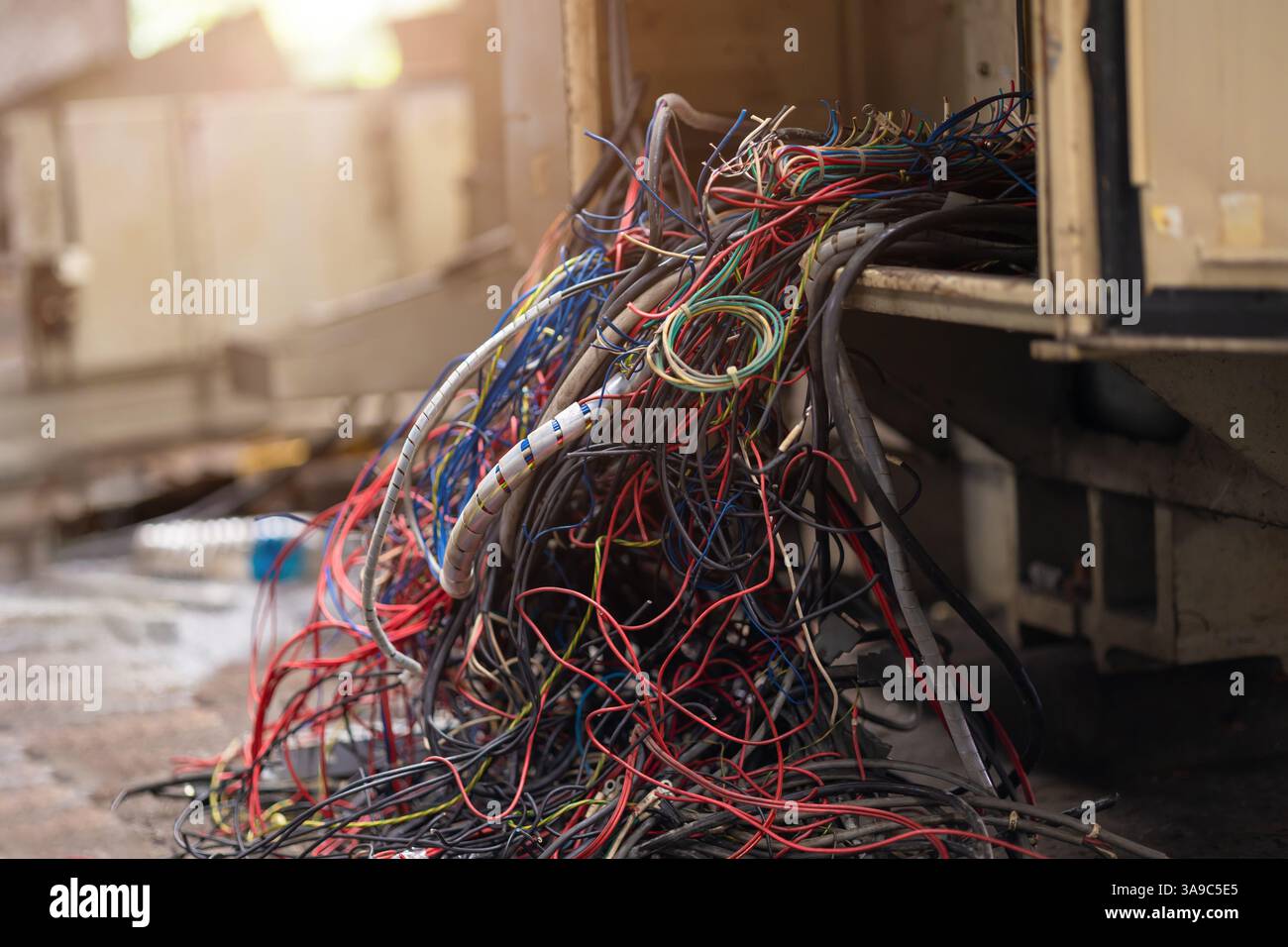 Electrical cable pile. tangled mess of electrical wires bulge out from discharge broken ...