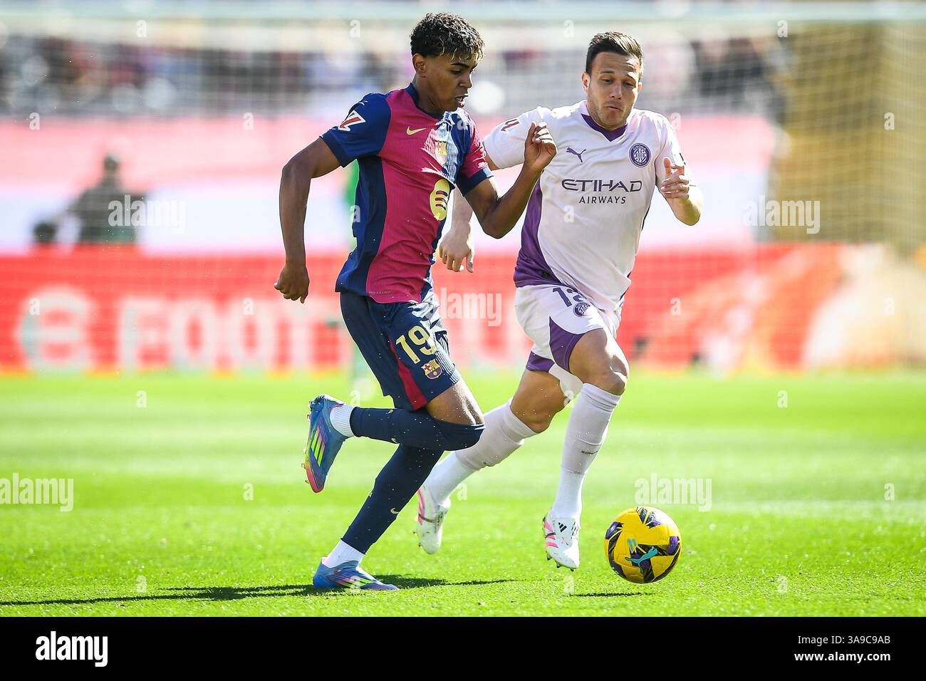 Lamine YAMAL of Barcelona and Arthur MELO of Girona FC during the ...