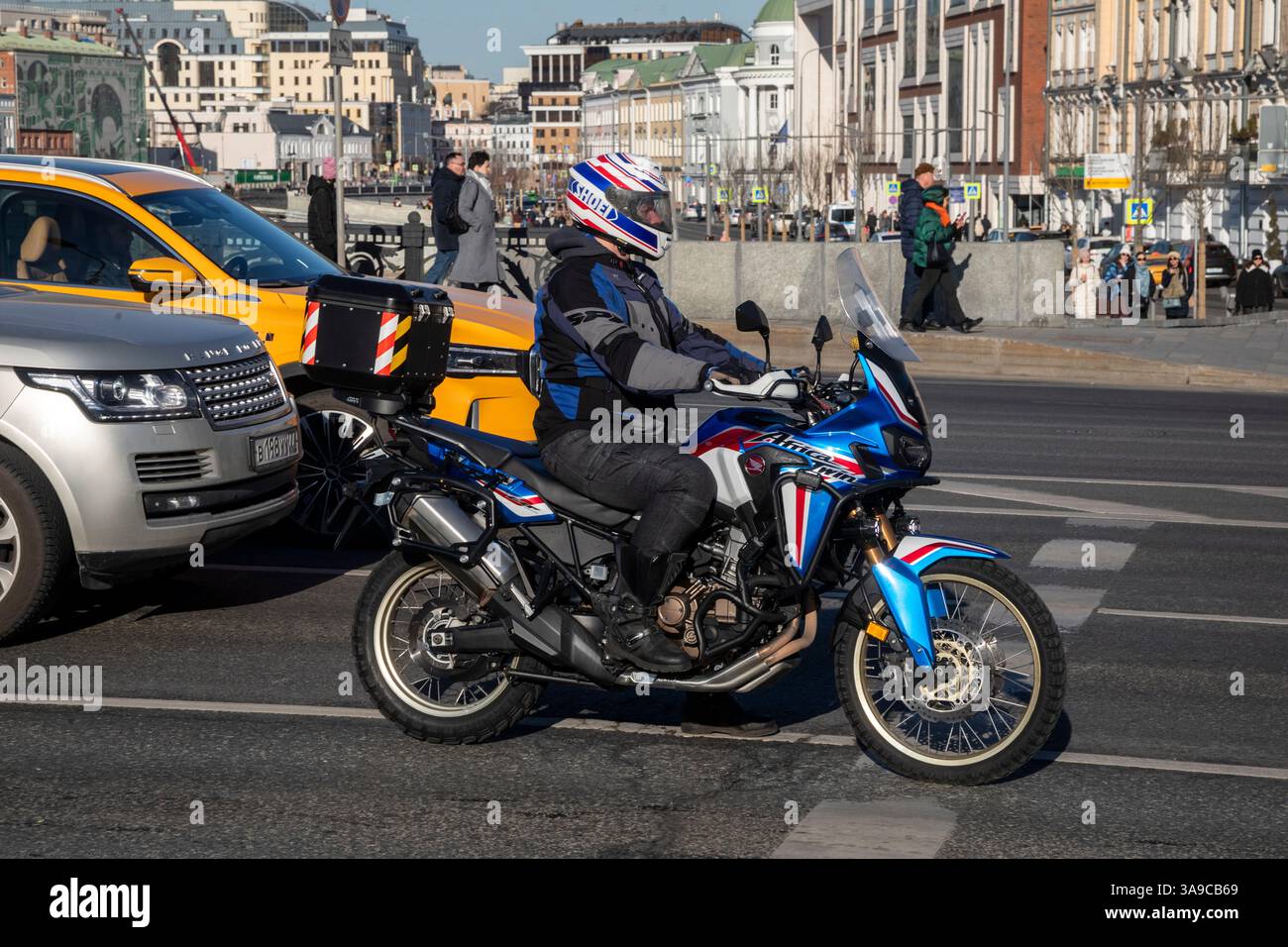 Moscow, Russia. 23rd of March, 2025. Road users stand at an ...