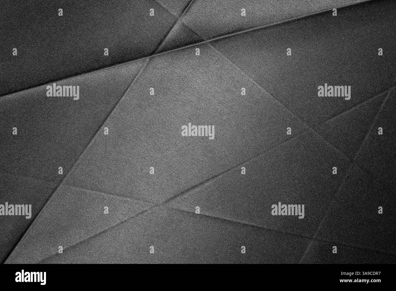 The Surface Showcases A Textured Black Fabric With Diagonal Lines Creating An Elegant