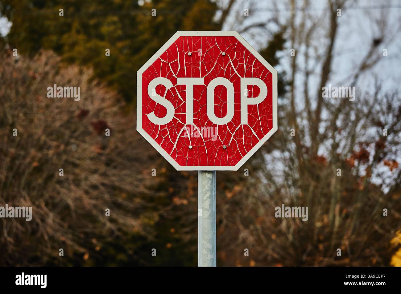 Stop sign with broken paint peeling Stock Photo - Alamy