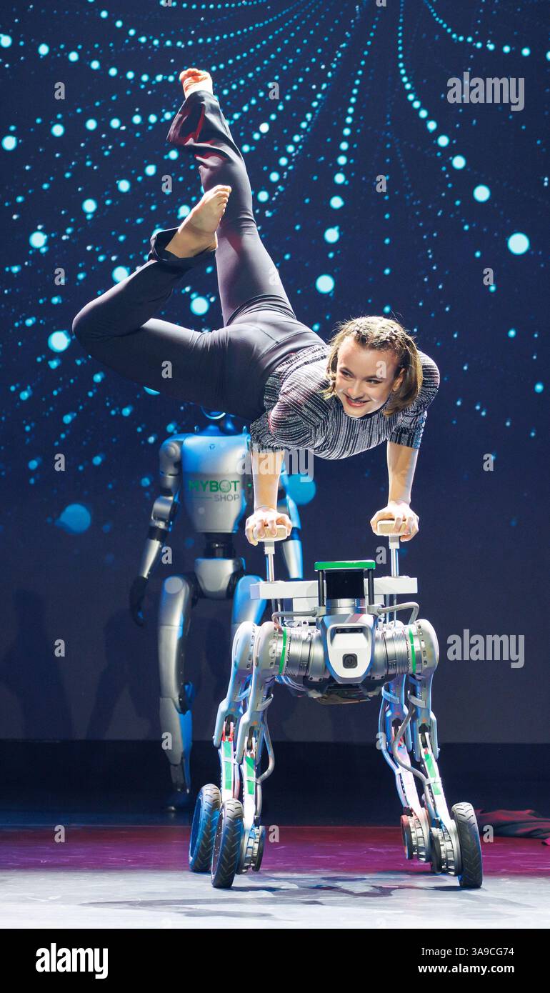 Hanover, Germany. 30th Mar, 2025. A dancer dances with a robot in the ...