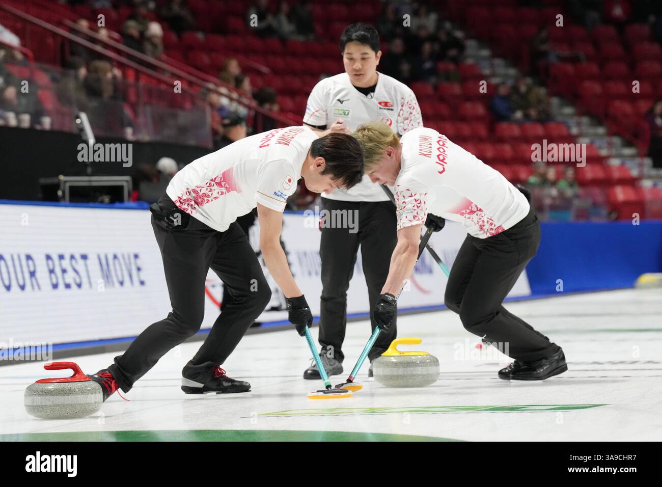 Japan's Satoshi Koizumi (right) and Riki Yanagisawa sweep a stone for ...
