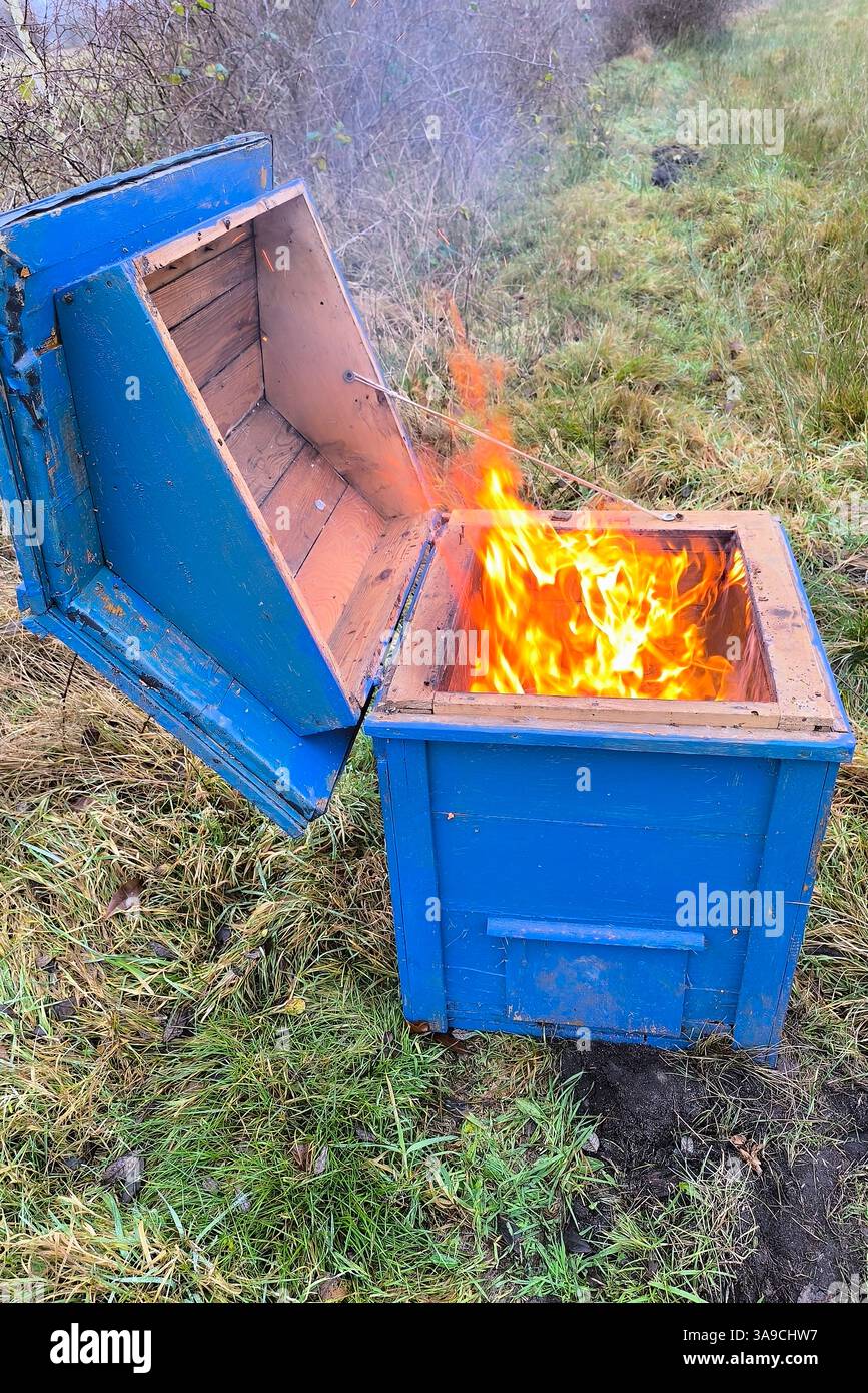 Detail of a burning beehive in an apiary. Chemical treatment and ...