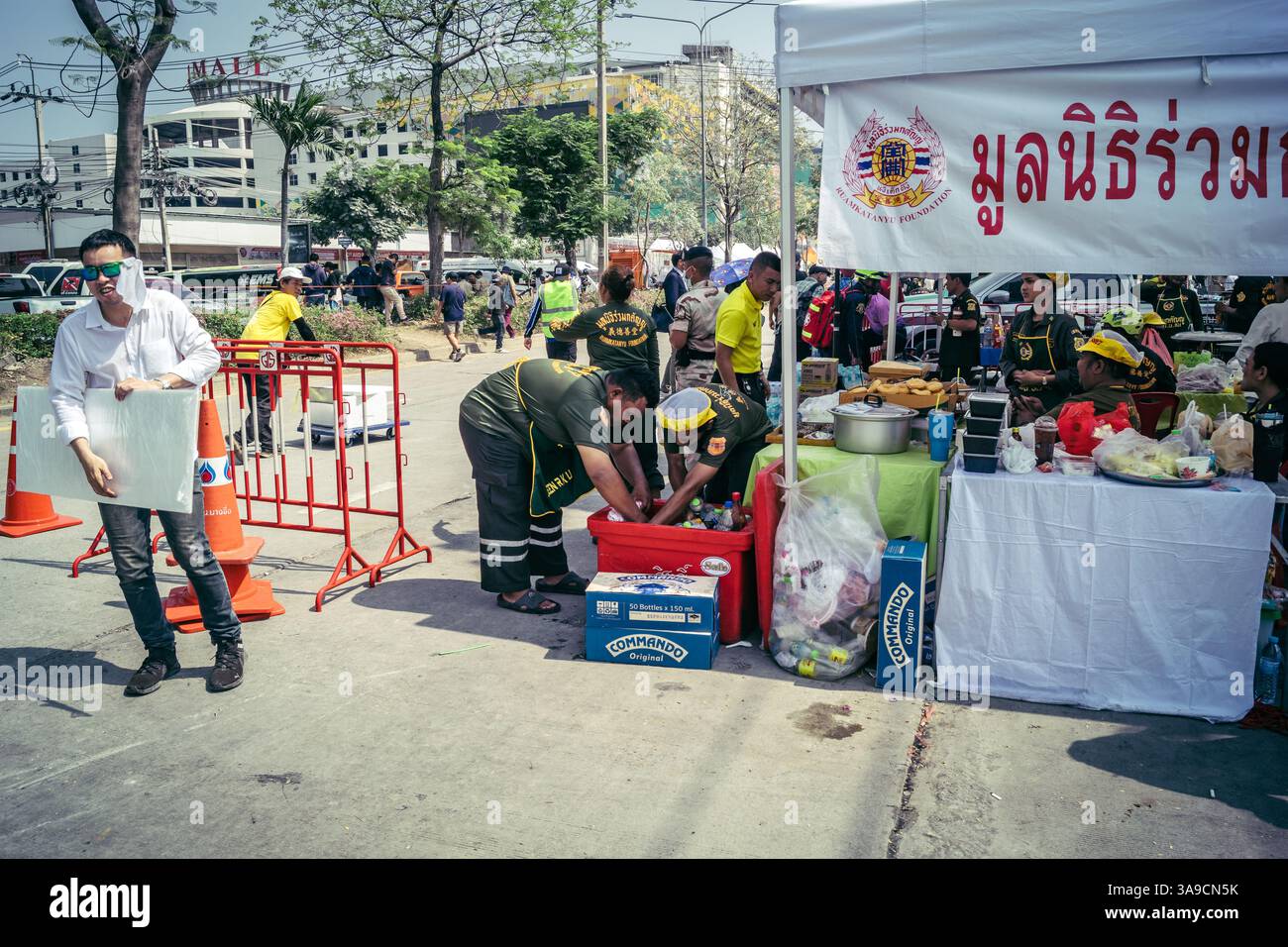 Bangkok, Thailand, March 29, 2025. Volunteers set up tents and ...