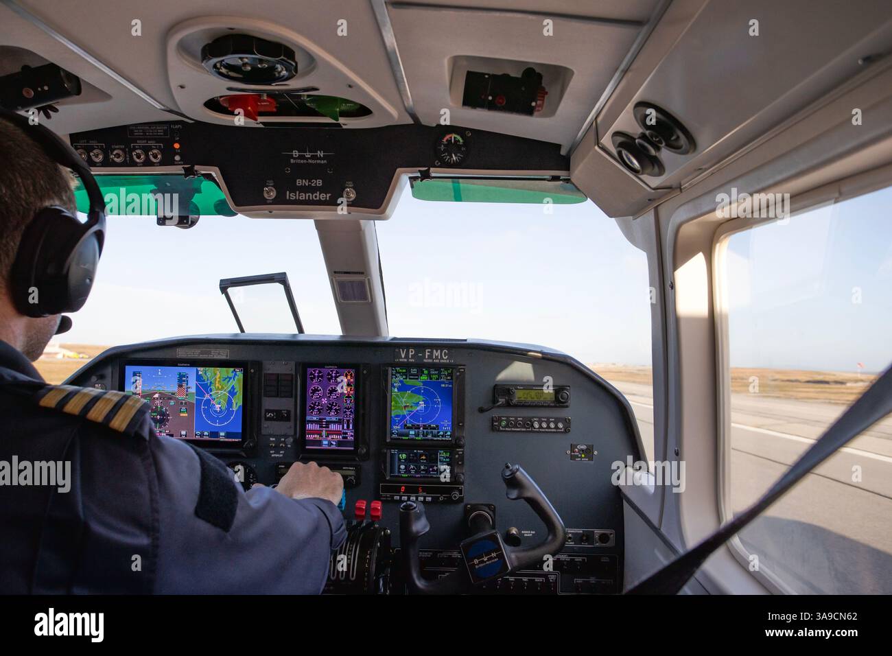A pilot in the cockpit of a Britten Norman Islander plane belonging to ...