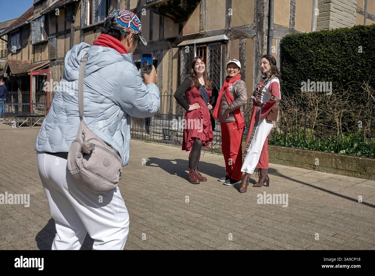 Shakespeare actors in period costume, pose with for a tourist at ...