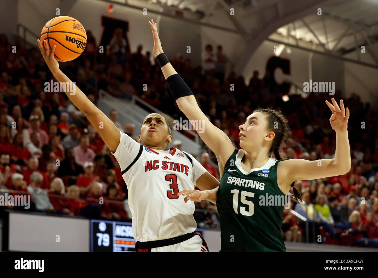 NC State's Zamareya Jones (3) shoots the ball past Michigan State's ...