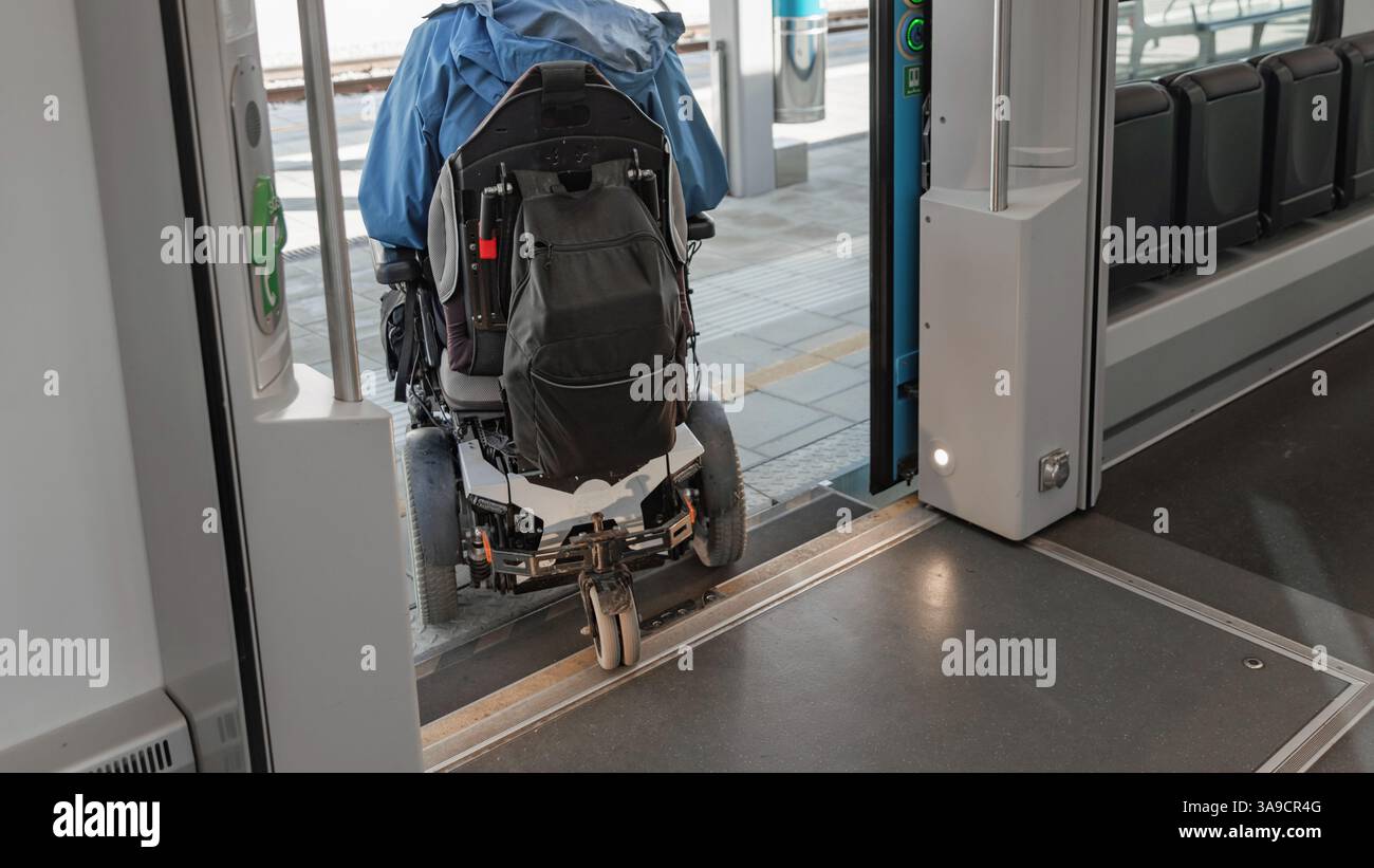 Man with disability on electric wheelchair exit a train. Accessible ...