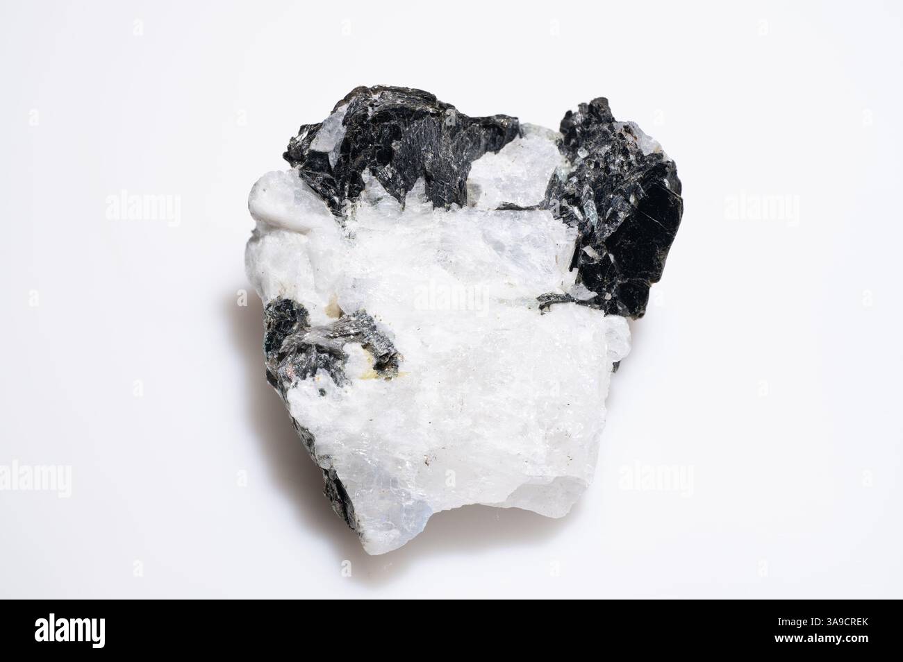 Raw Moonstone Mineral Specimen with Black Inclusions on White Surface ...