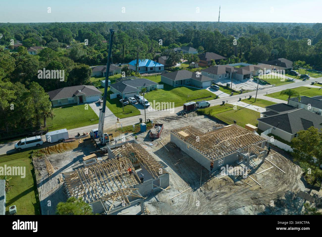 Aerial view of lifting crane and builders working on unfinished ...