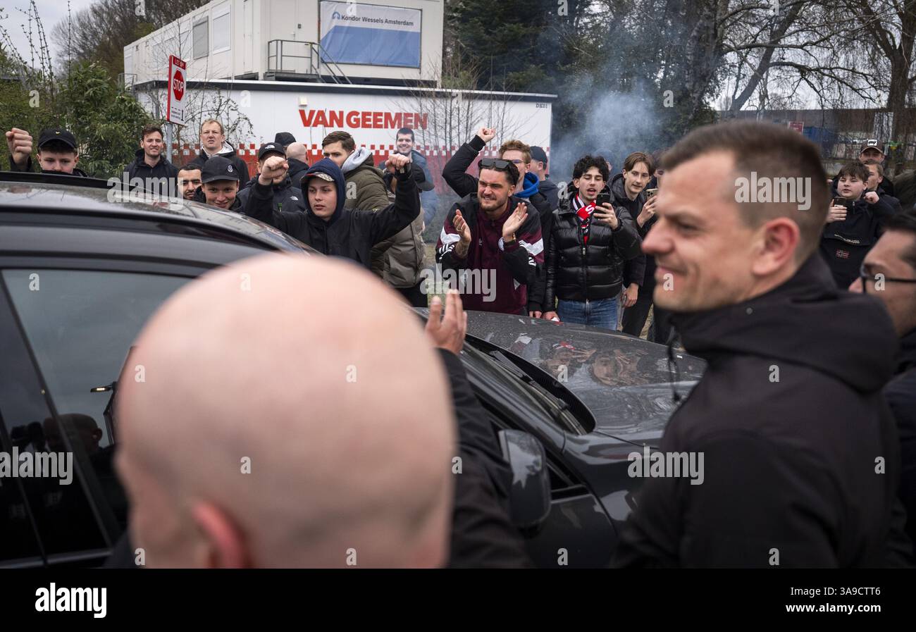 AMSTERDAM - Ajax supporters welcome the Ajax players upon arrival at ...