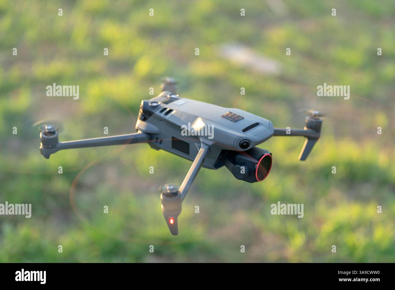 Drone aircraft with blurred fast rotating propellers and video camera ...