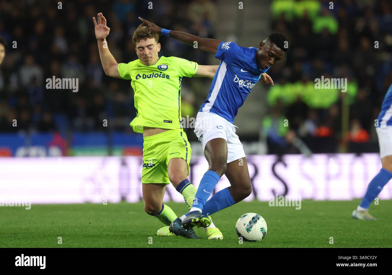 Genk, Belgium. 30th Mar, 2025. Genk's Ibrahima Bangoura and Gent's ...