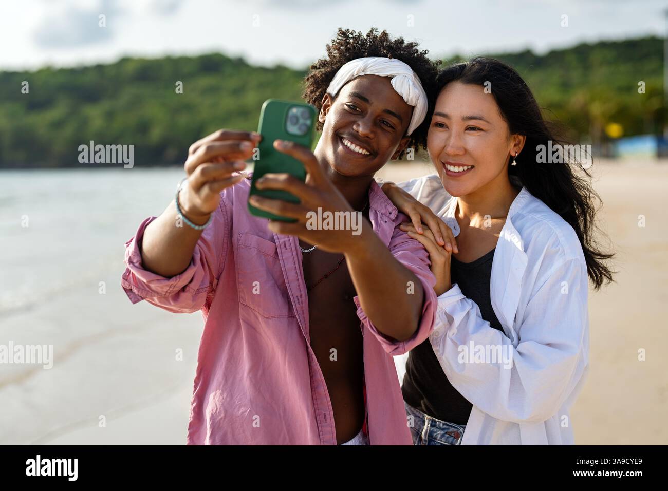 Diverse couple connected, embracing technology and social media while ...