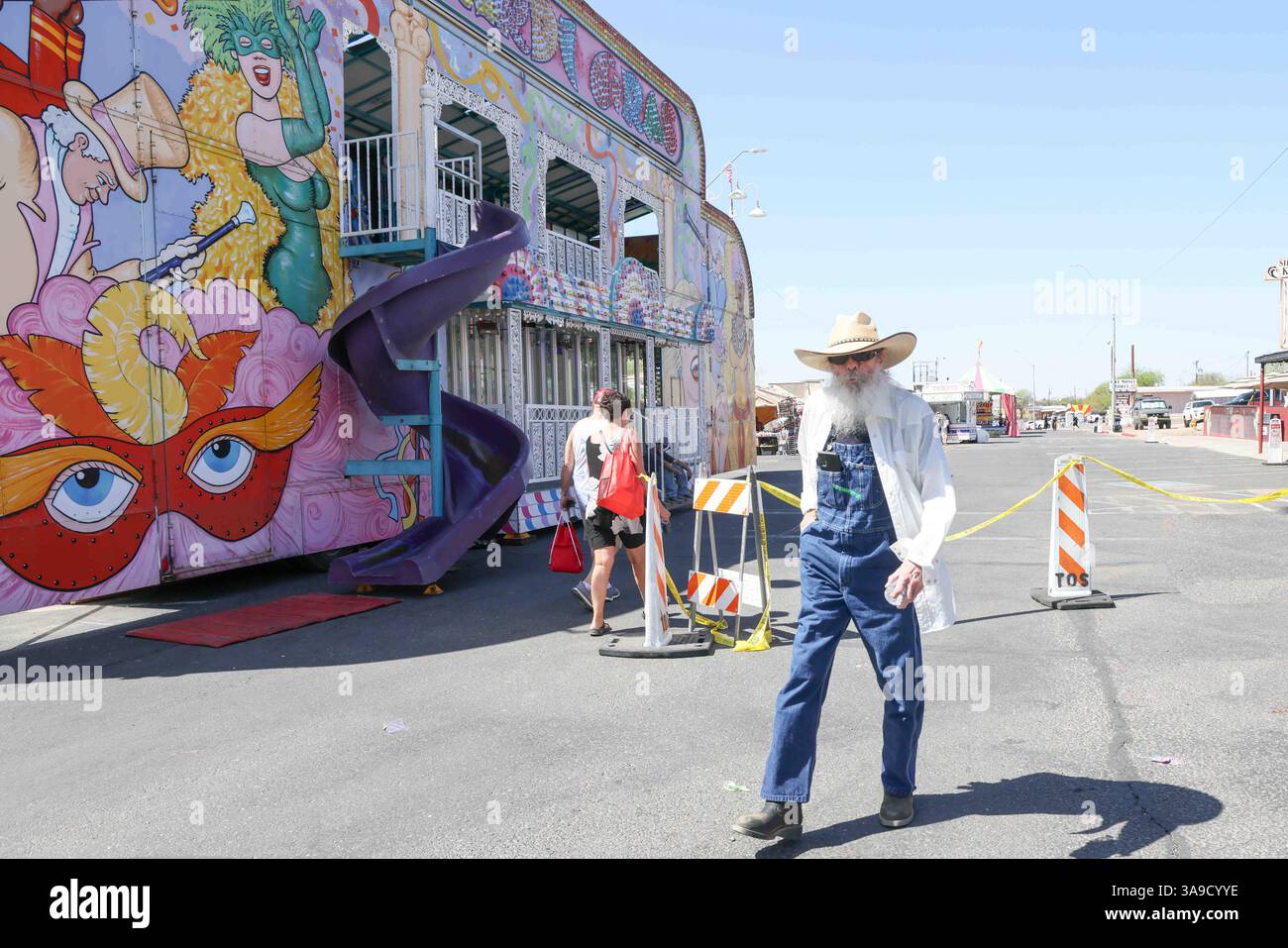 A man walks past the carnival house of mirrors during the 36 Annual ...