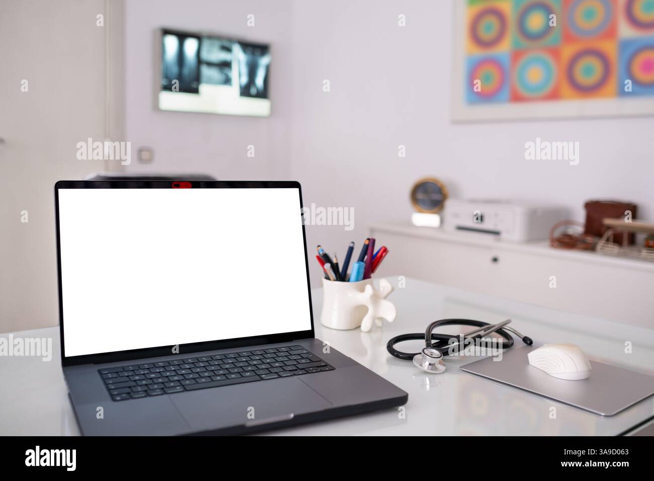 A laptop is on the doctor's table of a health office. mockup white ...