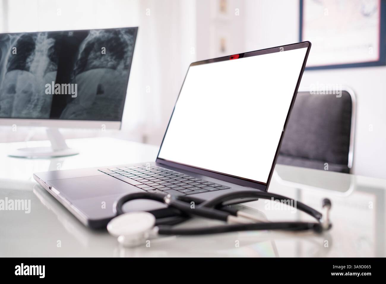 A laptop is on the doctor's table of a health office. white mockup ...