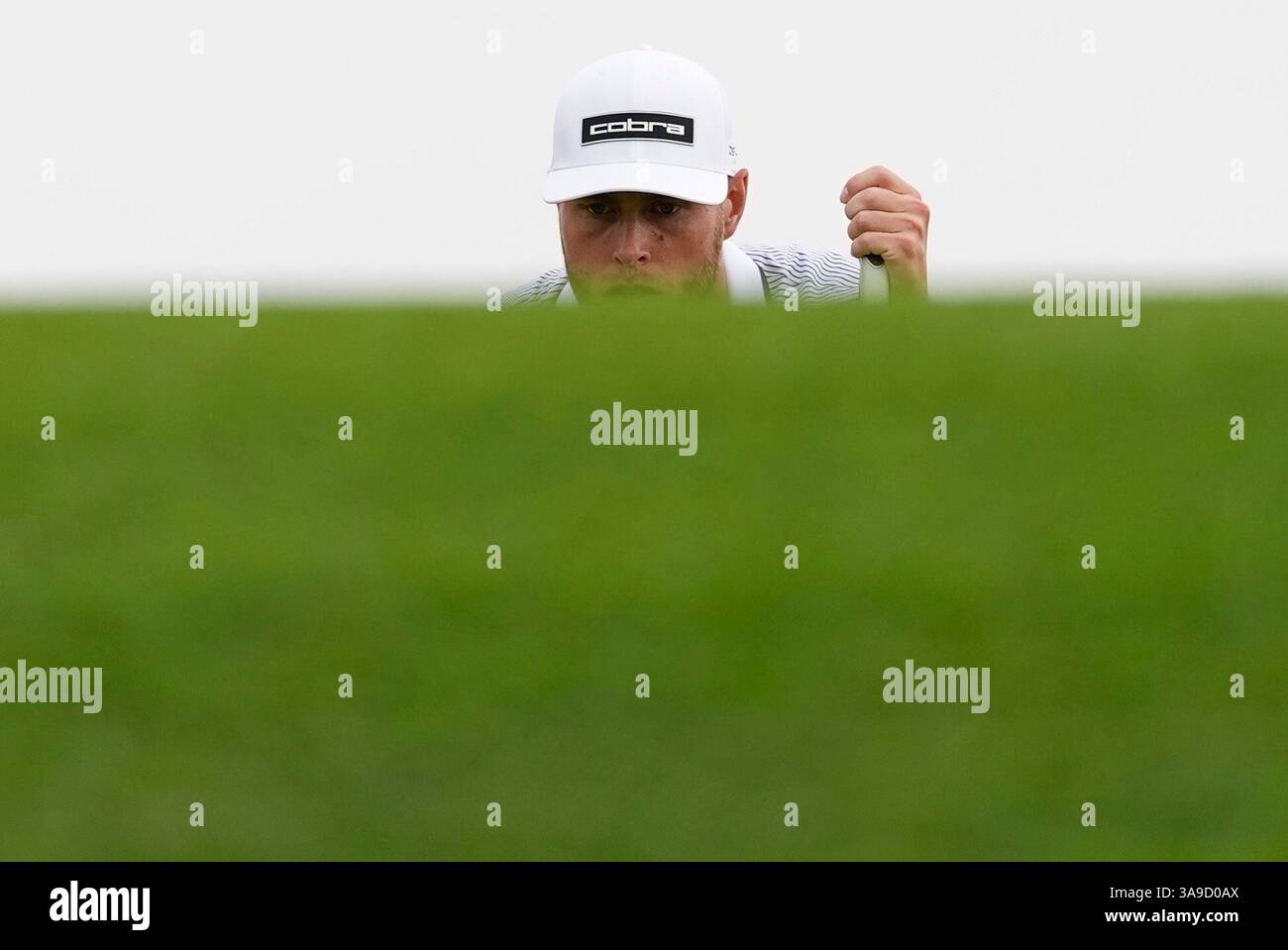 Jesper Svensson, of Sweden, lines up a shot on the fourth green during ...
