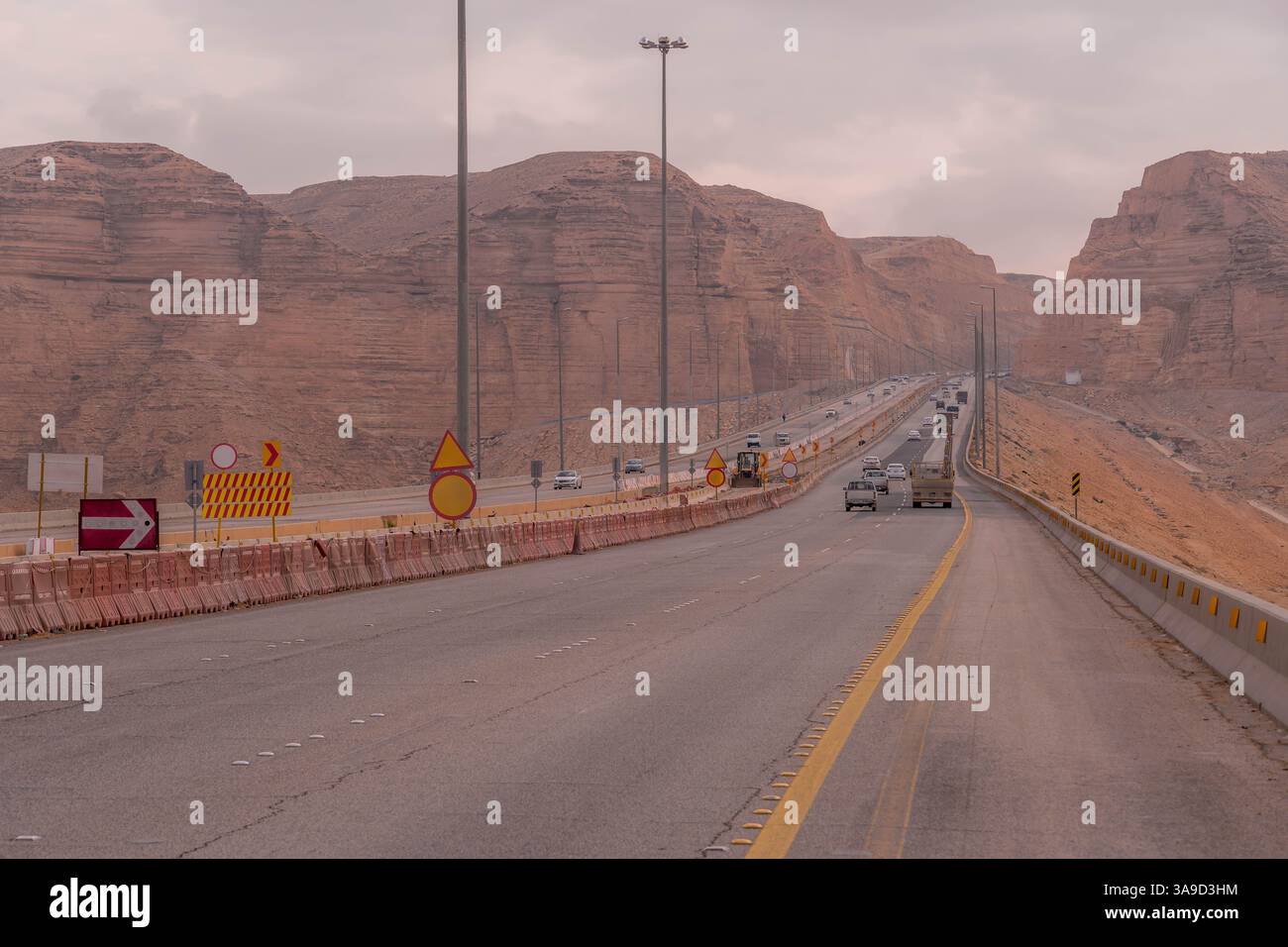 The cars on the highway going through rugged Saudi Arabia terrain with ...
