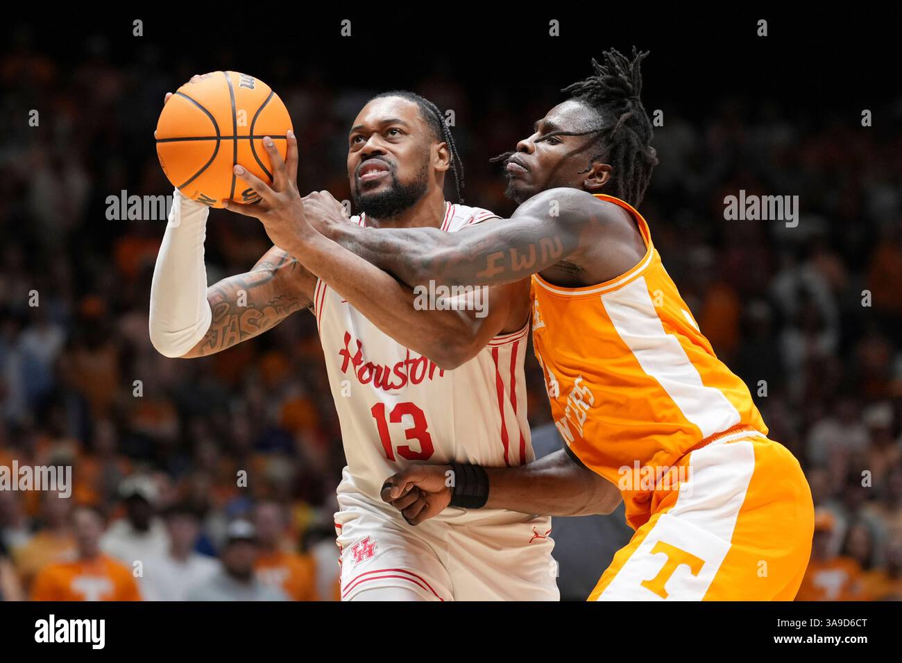 Houston's J'Wan Roberts (13) is fouled on his way to the basket by ...